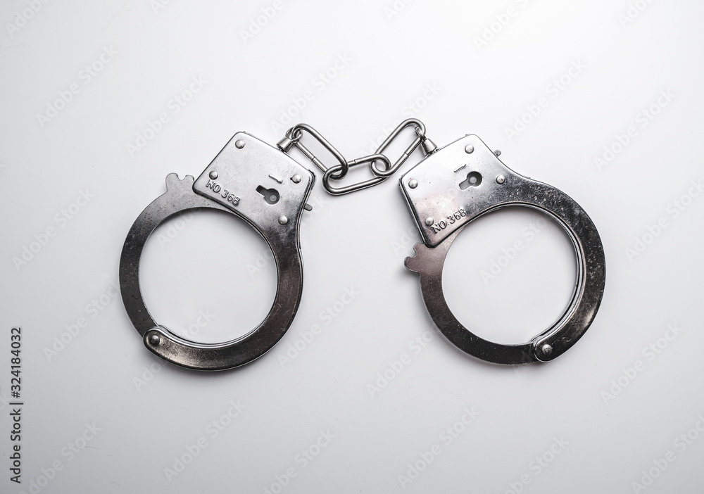 Handcuffs isolated on white background Stock Photo | Adobe Stock