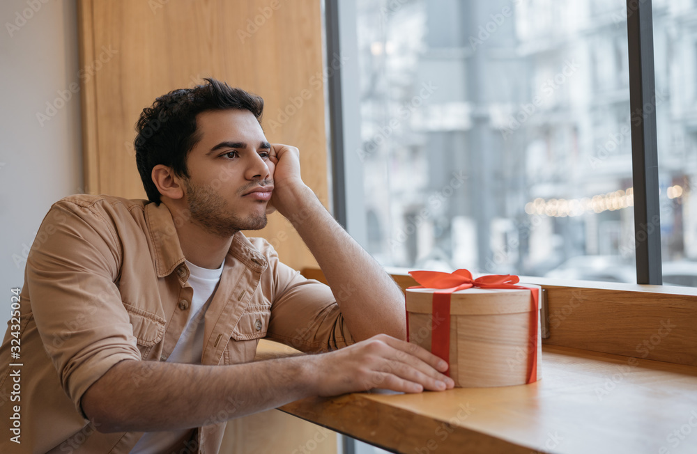 Sad unhappy Indian man sitting alone in cafe, waiting for girlfriend ...