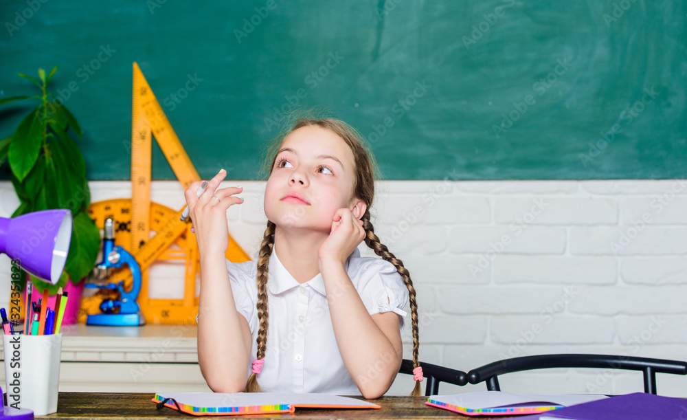 Girl cute child sit school classroom chalkboard background. Hooked on learning. Small kid study ...