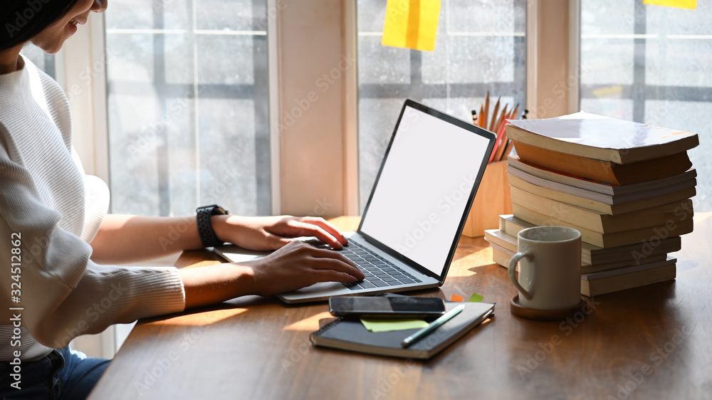 Cropped image of young beautiful woman working as writer typing on ...
