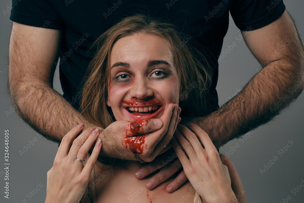 Strong man strangling scared female with bruises on her face. Blood ...