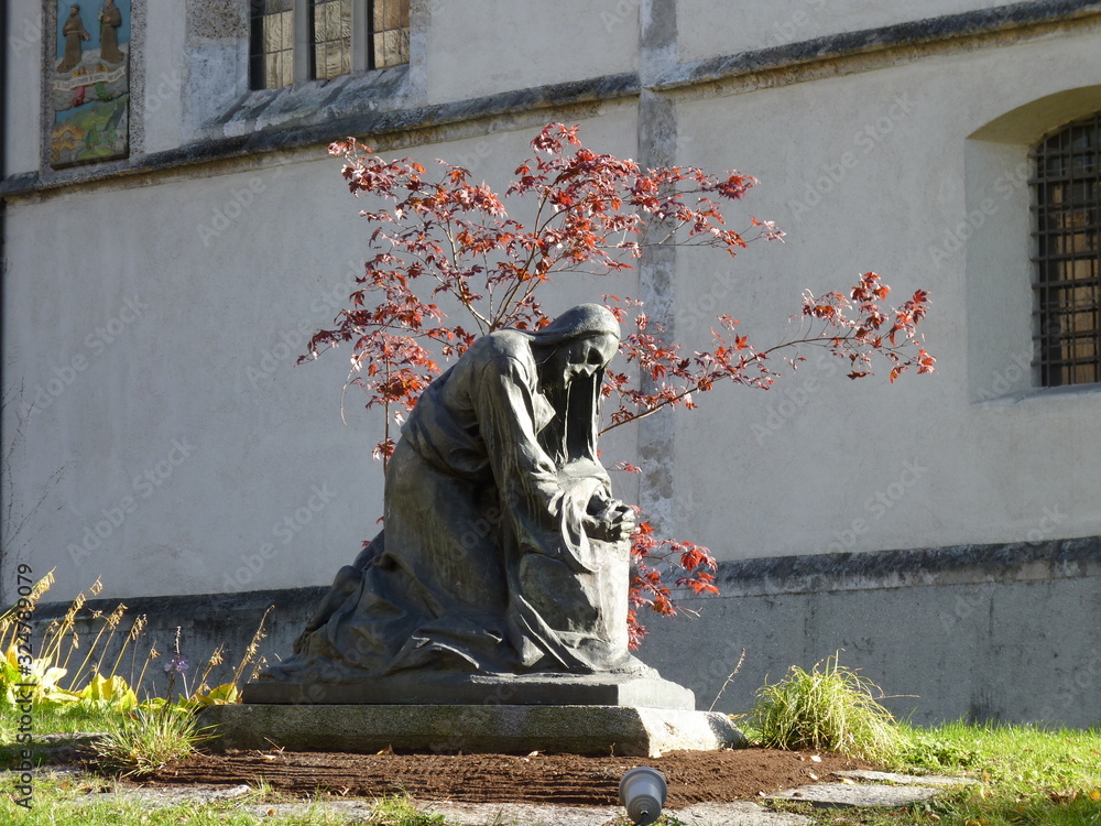 Old marble statue depicting evil form located in the city center ...