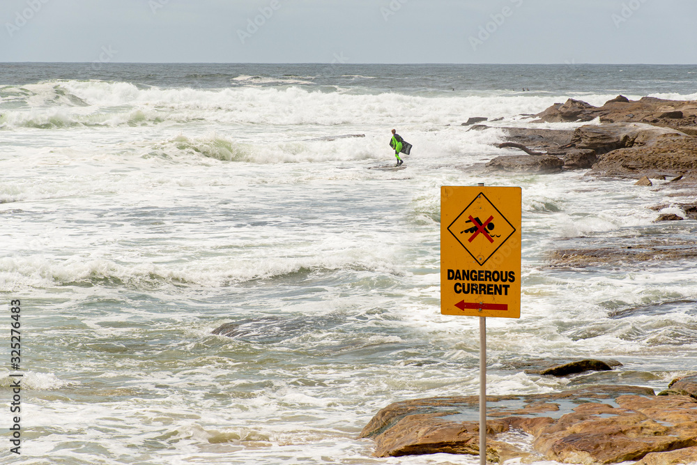 Dangerous current sign for swimmers at the beach in Australia. Lonely ...