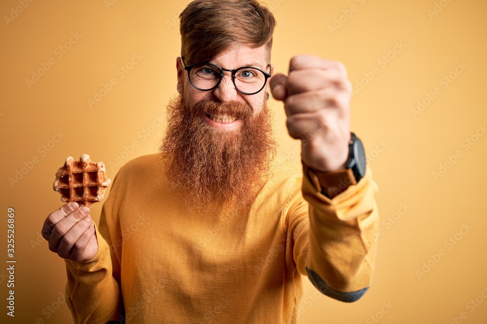 Redhead Irish man with beard eating sweet belgian waffle pastry over ...