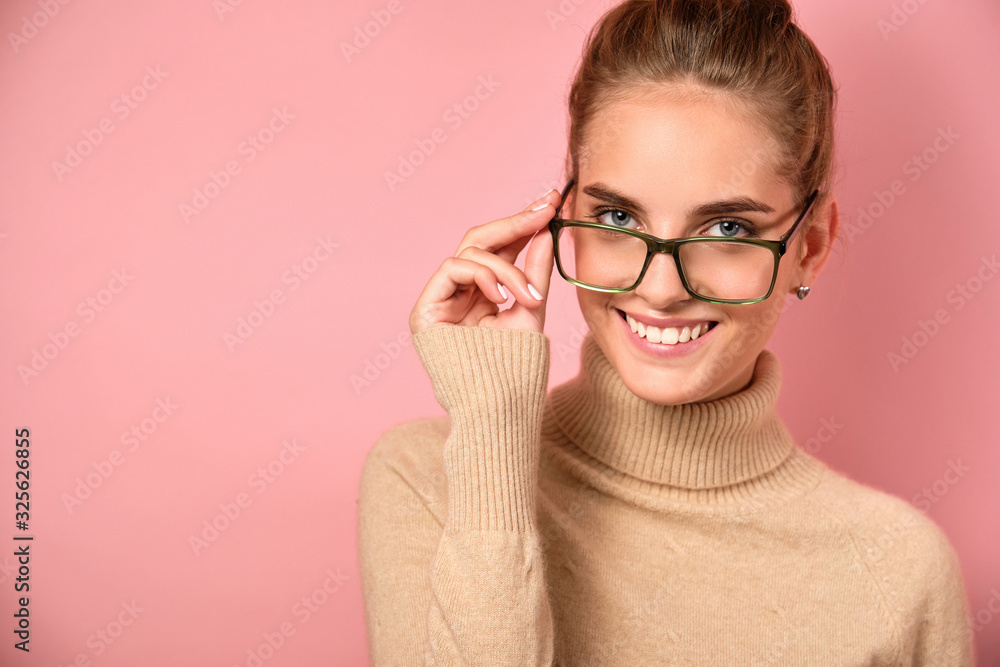 A girl in a turtleneck with a high beam on her head, smiling, looks ...