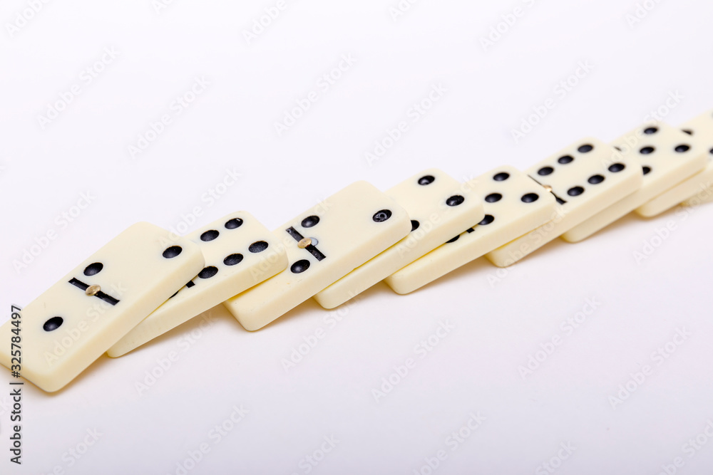 Domino's effect composition of a multiple domino bones placed in a row ...