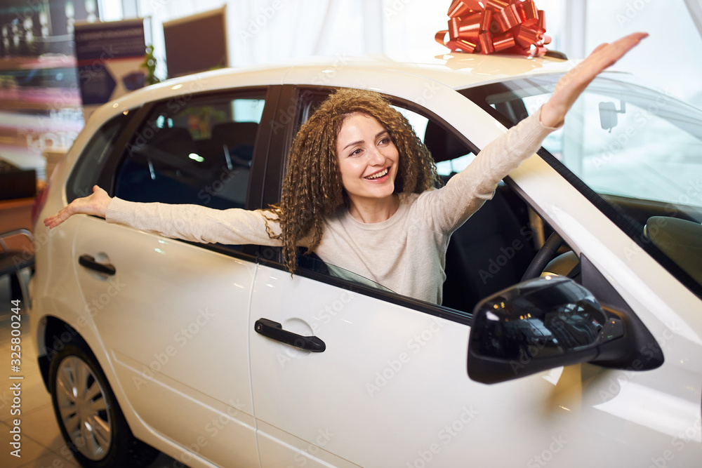 positive smiling beautiful girl sticking out the car window celebrating ...