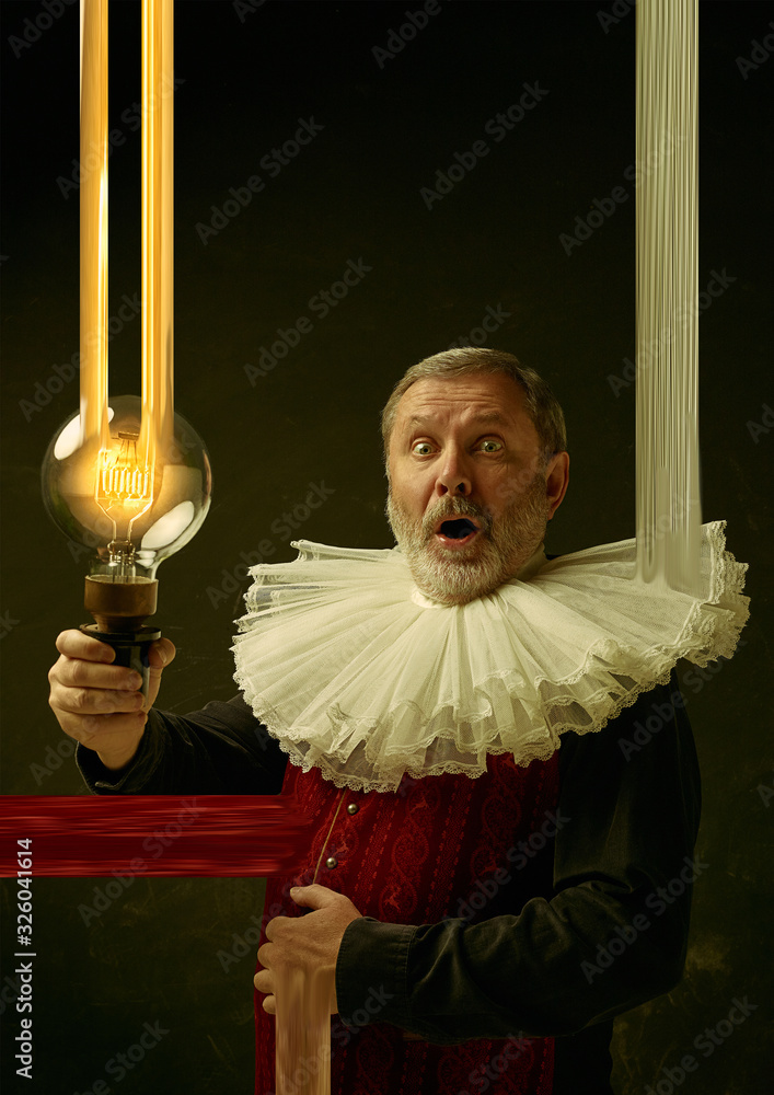 Light bulb. Senior man as a medieval knight, duke on dark studio ...