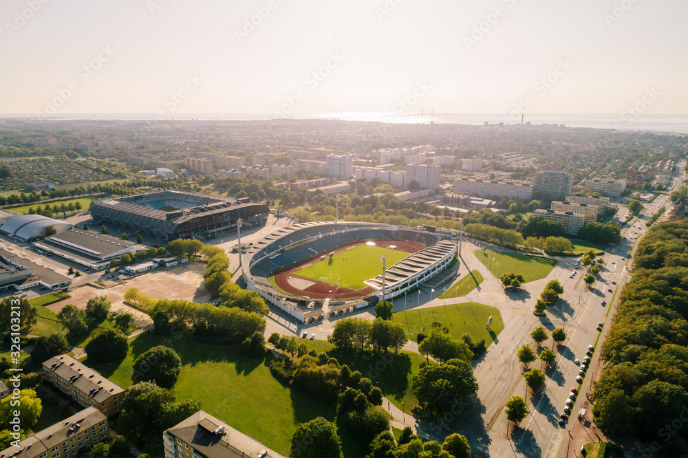 Aerial view of stadium in city against sky on sunny day Stock Photo ...