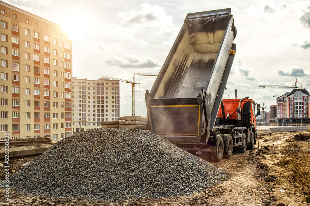 Construction truck tipping dumping gravel on road construction site,tip ...