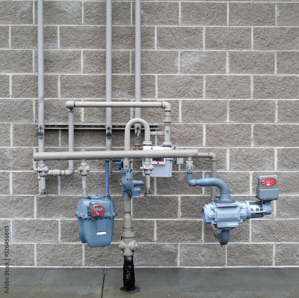 Commercial gas meter and piping mounted on building exterior. Stock ...