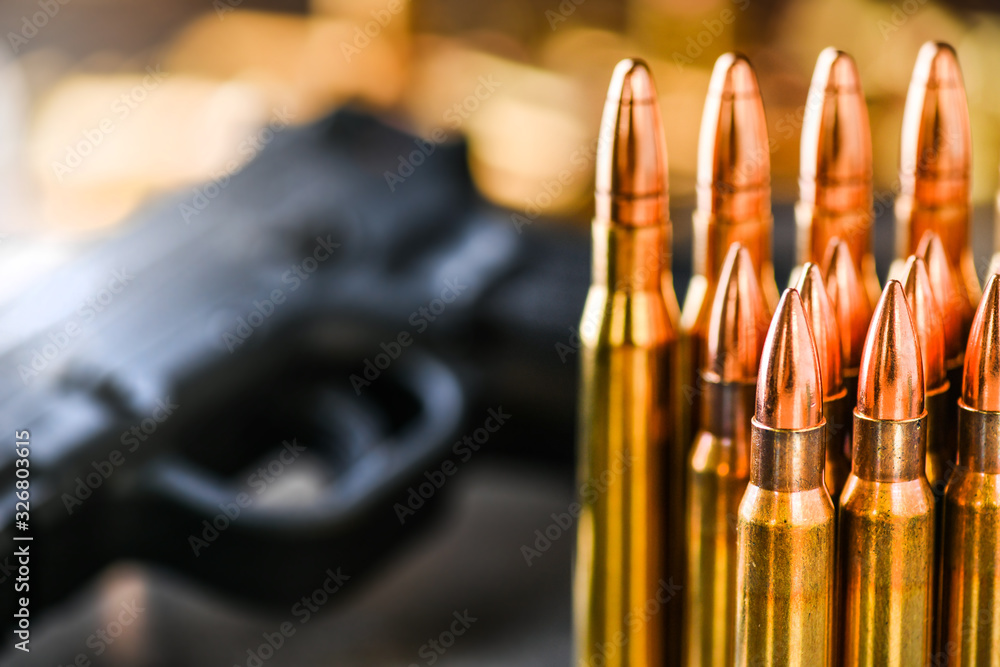 Various kind of bullets or ammonution on dark stone table. Bullet pile ...