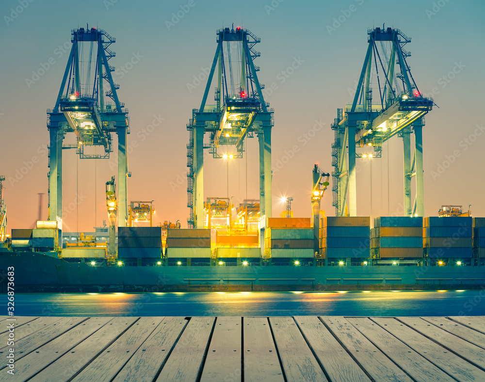 Gantry crane loading and unloading cargo container from cargo ship at ...