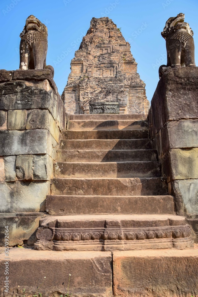 vertical picture of two stone lion statues guarding stairs to ancient ...