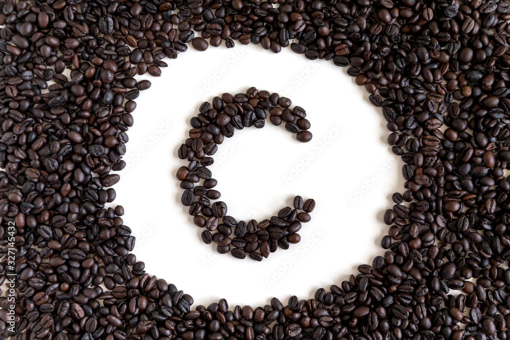 Letter C made out of aromatic coffee beans, top view, isolated on white ...