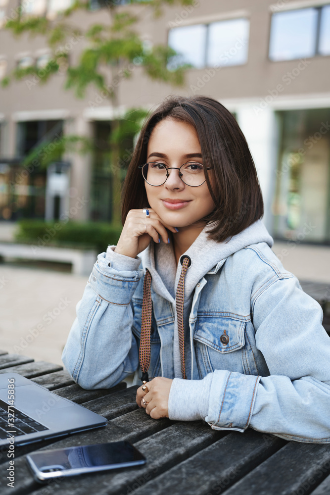 Education, career opportunities concept. Attractive smart female student studying in park ...