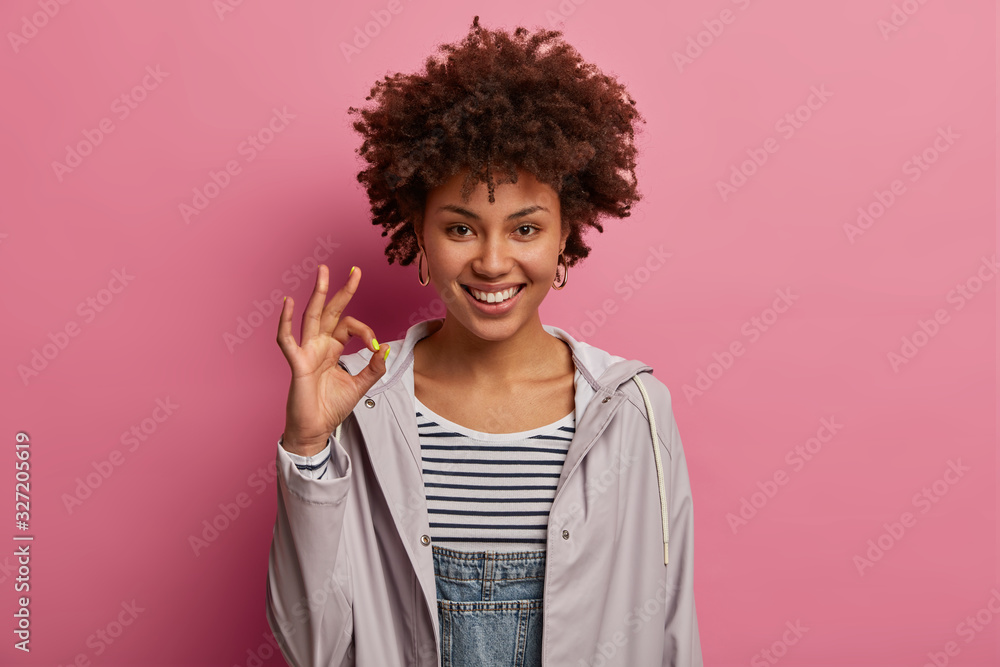 Smiling positive African American woman agrees with you, gives ...
