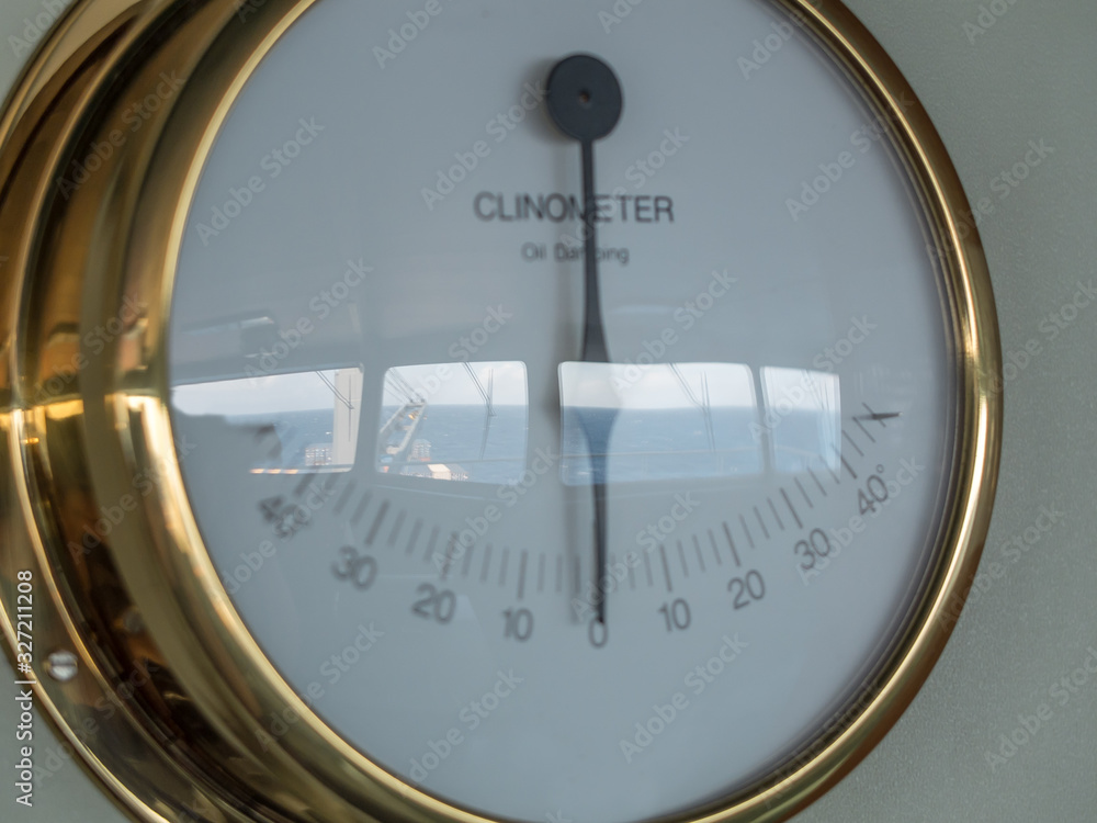 A close up of the traditional ship clinometer with reflection of the ...