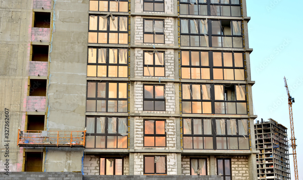 Suspended construction cradle on the background facade of the building ...