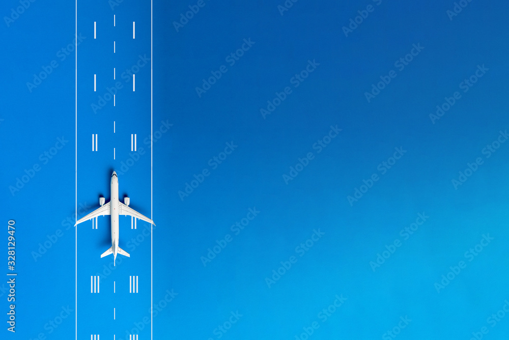 The passenger plane on airport runway and blue background with empty ...