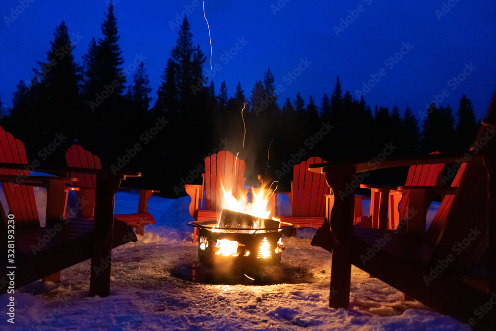 Cozy/romantic evening scene of warming bonfire on snow in winter with ...
