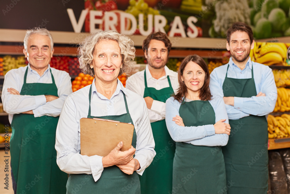 Happy group of sellers in the supermarket Stock Photo | Adobe Stock