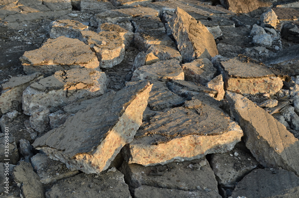 Broken pieces of asphalt at a construction site. Recycling and reuse ...