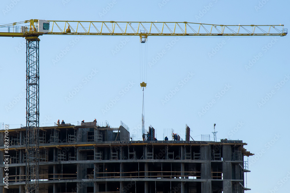 Hydraulic luffing jib tower cranes and workers being poured concrete ...