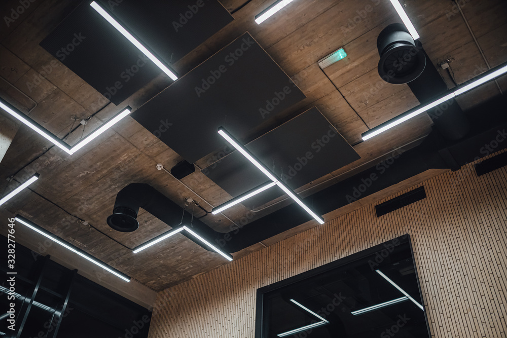 View on modern led lightning hanging from ceilings, industrial building ...
