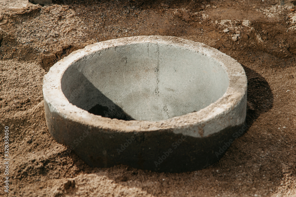 concrete circle for a well and sewerage buried in sand Stock Photo ...