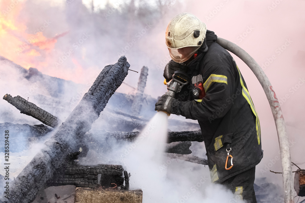 Brave firefighter saving burning building. Firefighter work concept ...