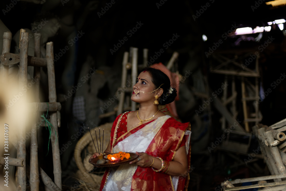 An young and beautiful Indian Bengali brunette woman in red white ...