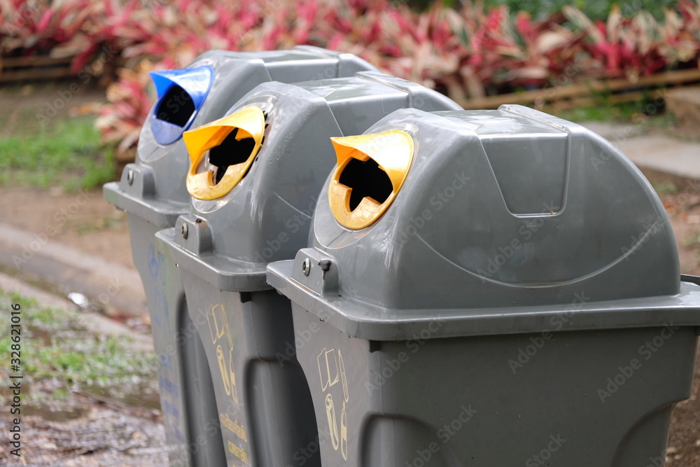 Plastic bins are placed in the park so people can use the service ...