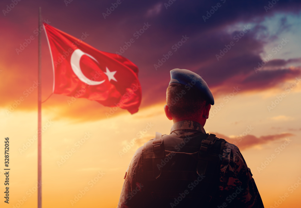 Turkish Soldier is stand and salute front of Turkish Flag on his watch ...