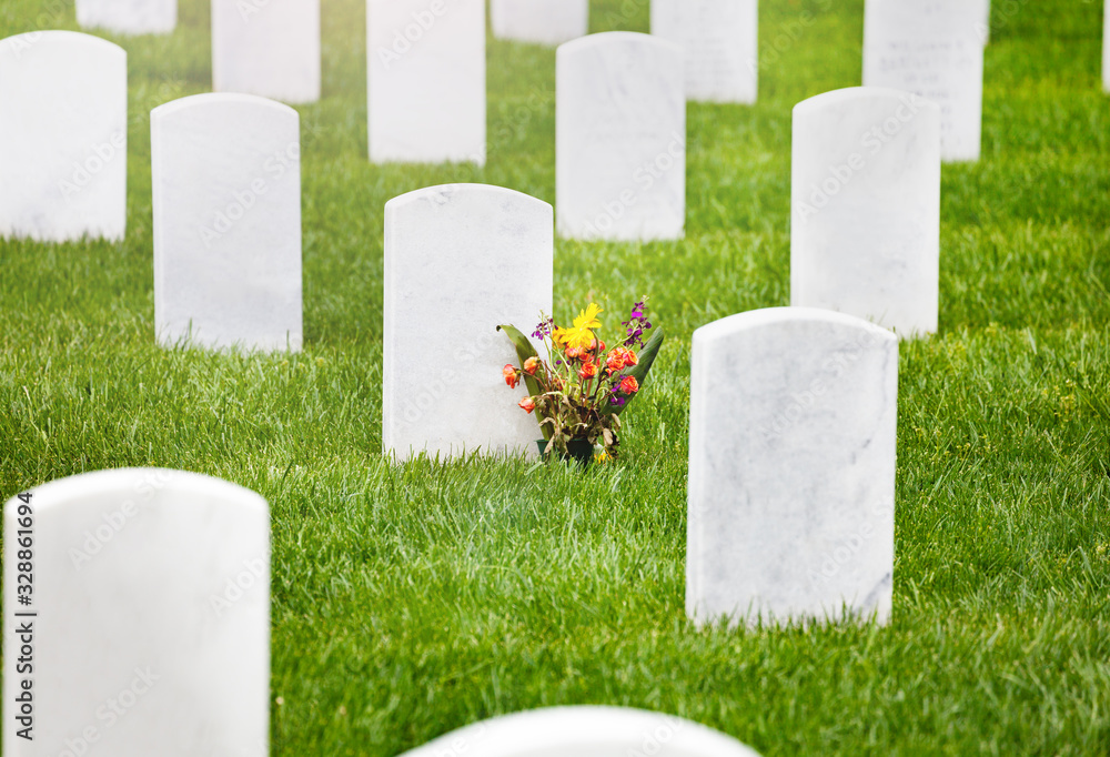 Flowers on the tombstone of military cemetery graveyard many white ...