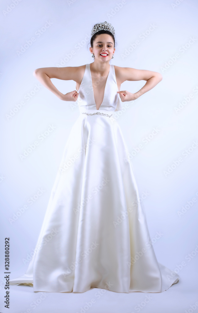 Angry woman bride in wedding dress shows her muscles flexing biceps ...