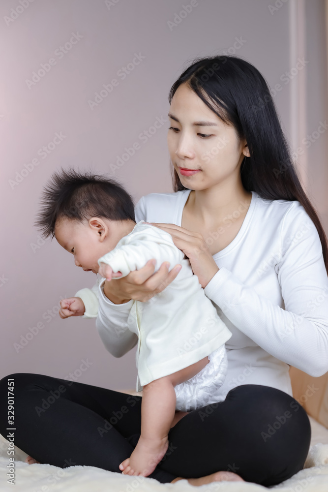 Infant baby boy belching after drink breast milk by mother Stock Photo ...