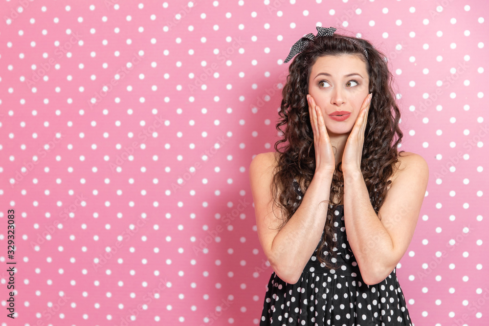 Kinky young pinup girl with thoughtful face expression, keeping her ...