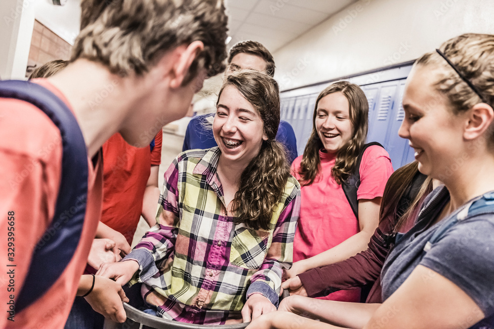 School kids hanging out in the hallway and at the lockers of their ...