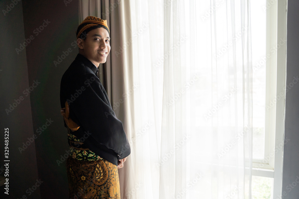 Young asian man wearing traditional clothes,beskap is traditional ...