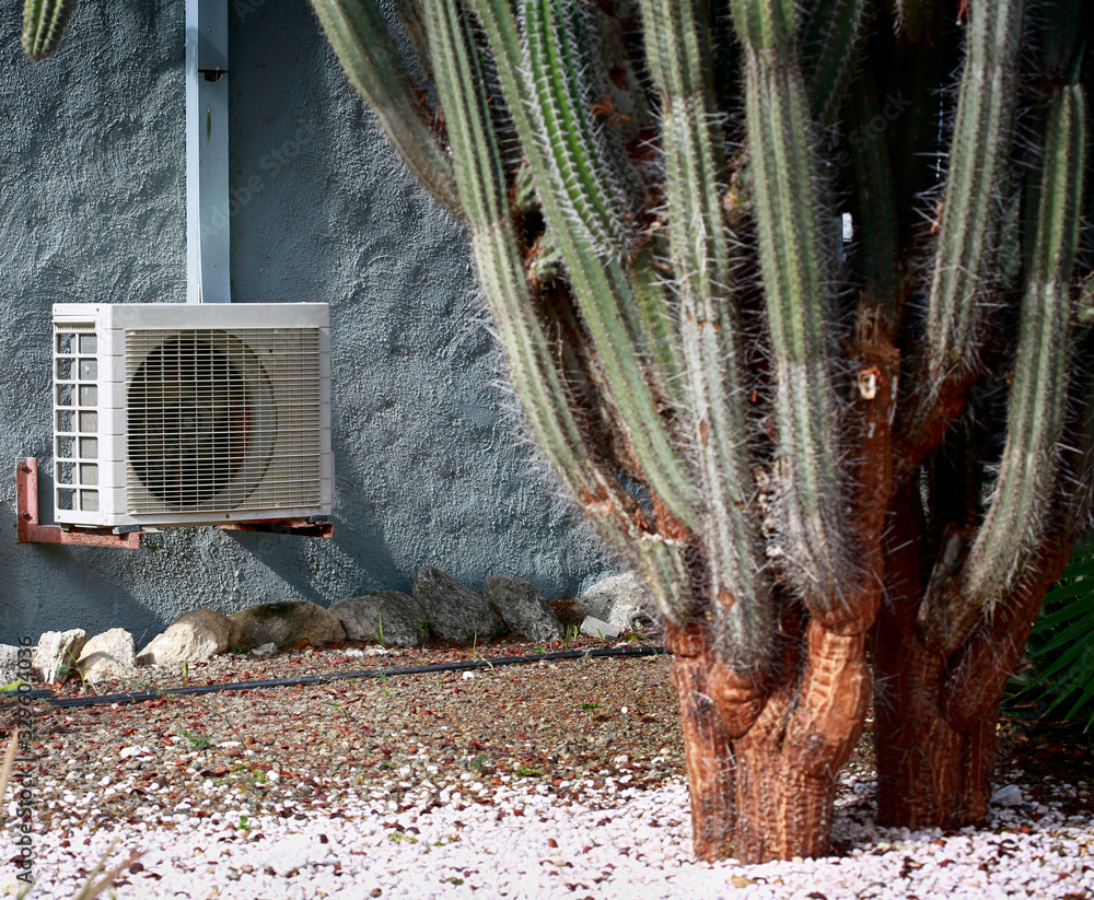 Split system air conditioner unit on stucco wall in hot tropical ...