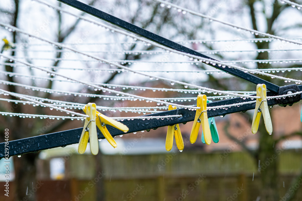 Yellow laundry clips in the rain, wet laundry drainer, bad time for ...
