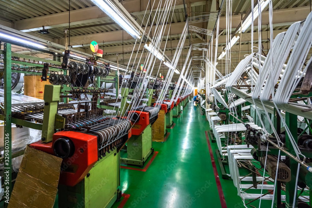 Elastic weaving workshop at textile factory in industrial zone in Ho ...