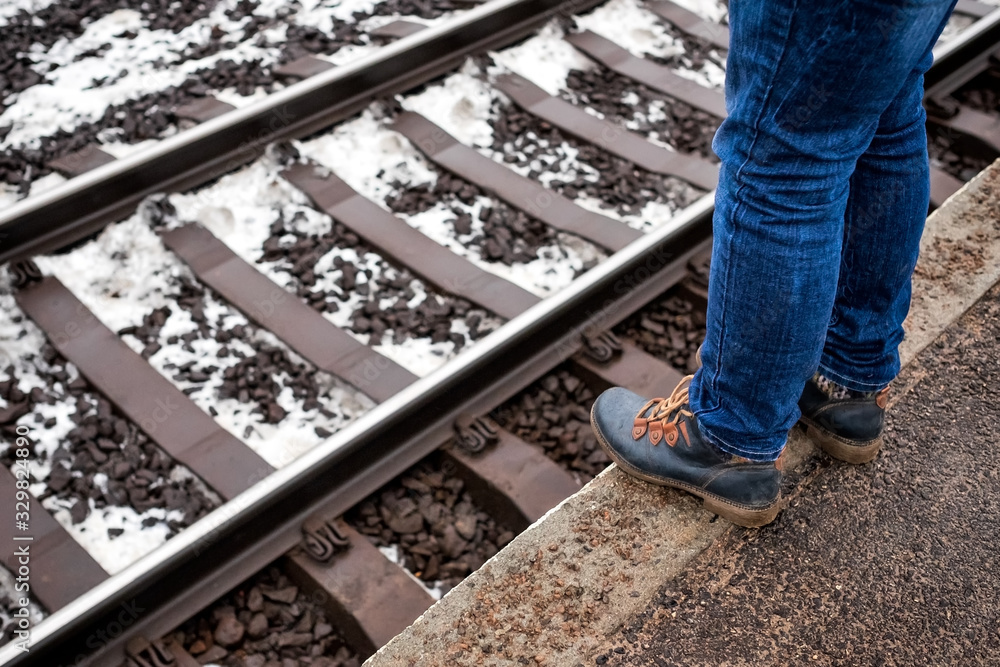 Woman standing waiting train at platform standing too close to the edge ...