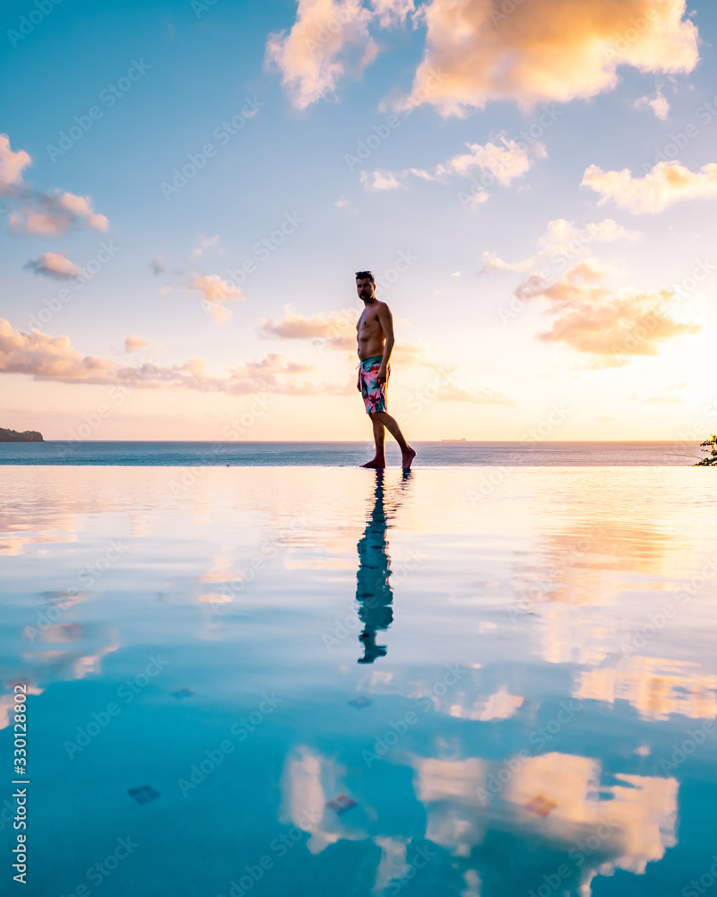 St Lucia Island Caribbean, young guy watching sunset at the pool , men ...