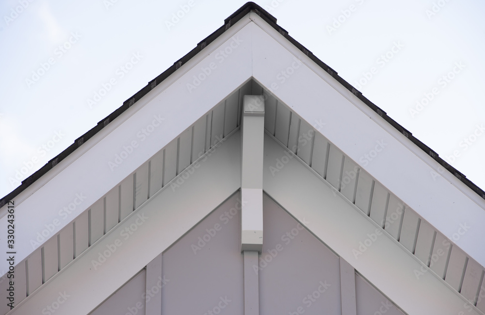 White decorative corbel, bracket, brace on a triangle gable roof, white ...