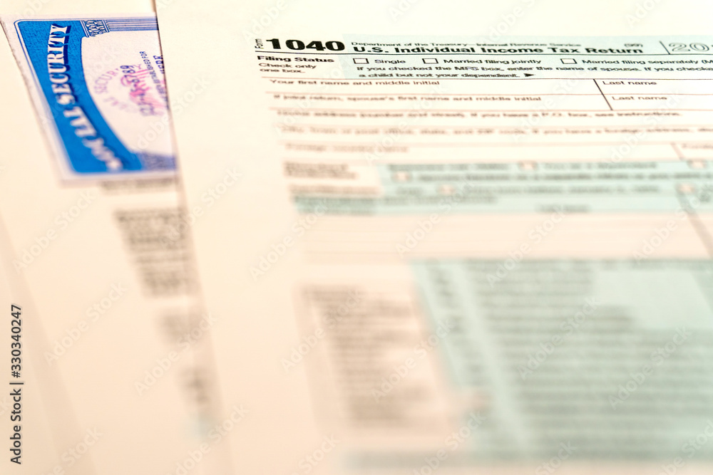 Individual Income Tax Return Form 1040 and social security card of USA ...