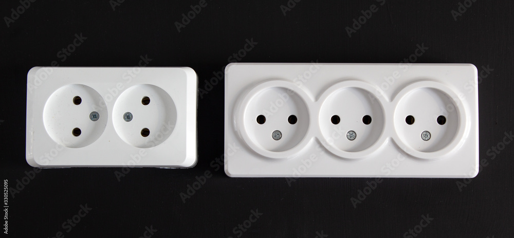 Two bright rectangular sockets lying side by side in a horizontal ...