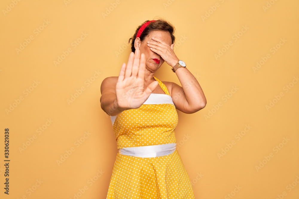 Middle age senior pin up woman wearing 50s style retro dress over ...