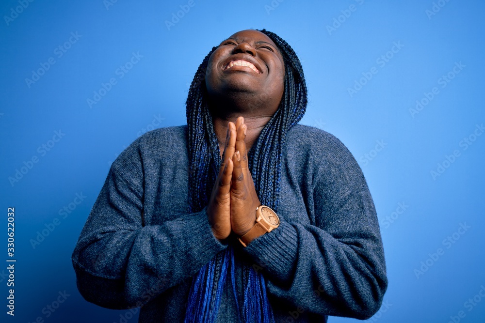 African american plus size woman with braids wearing casual sweater ...